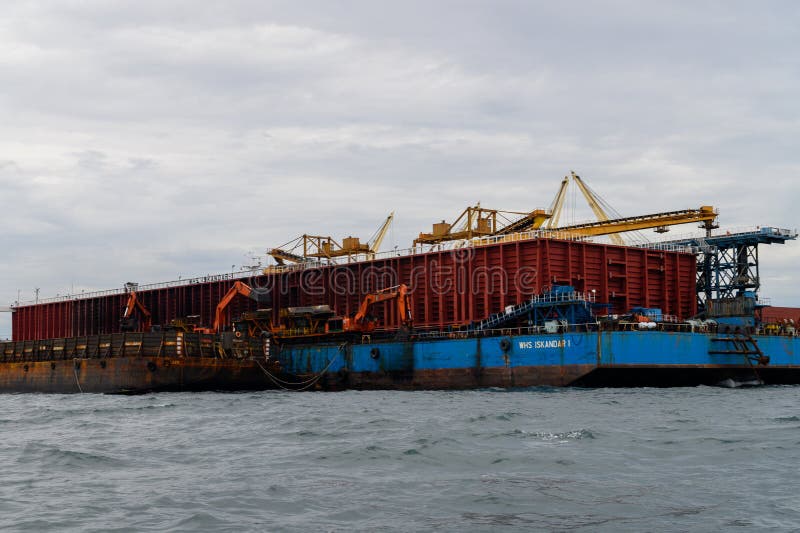 Loading Coal from Cargo Barges Onto a Bulk Vessel Using Ship Cranes ...