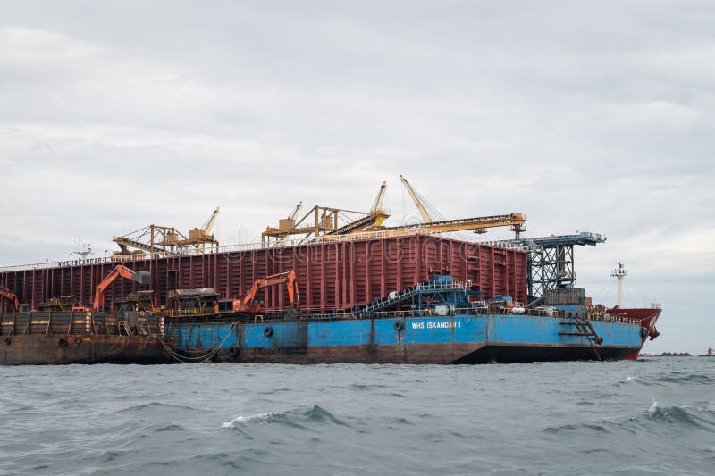 Loading Coal from Cargo Barges Onto a Bulk Vessel Using Ship Cranes ... Loading Coal from Cargo Barges Onto a Bulk Vessel Using Ship Cranes ...