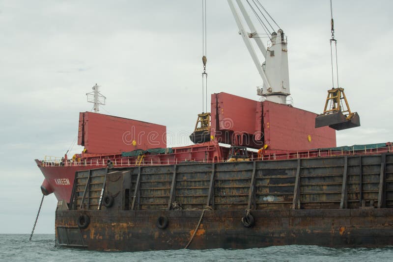 Loading Coal from Cargo Barges Onto a Bulk Vessel Using Ship Cranes ...