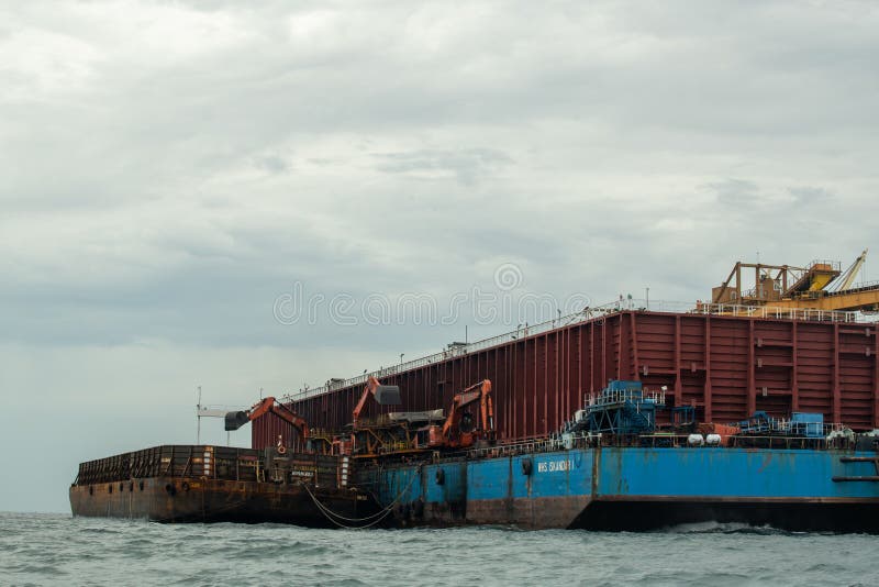 Loading Coal from Cargo Barges Onto a Bulk Vessel Using Ship Cranes ...
