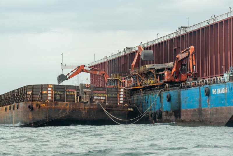 Loading Coal from Cargo Barges Onto a Bulk Vessel Using Ship Cranes ...