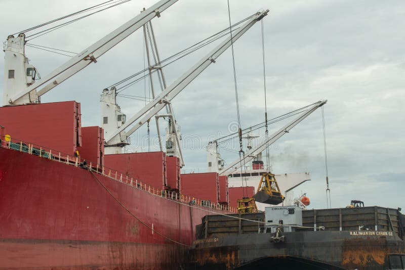 Loading Coal from Cargo Barges Onto a Bulk Vessel Using Ship Cranes ...