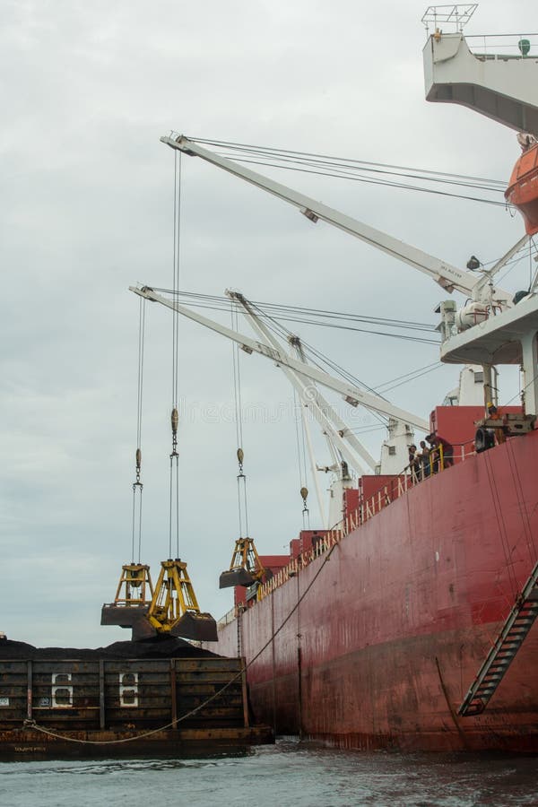 Loading Coal from Cargo Barges Onto a Bulk Vessel Using Ship Cranes ...