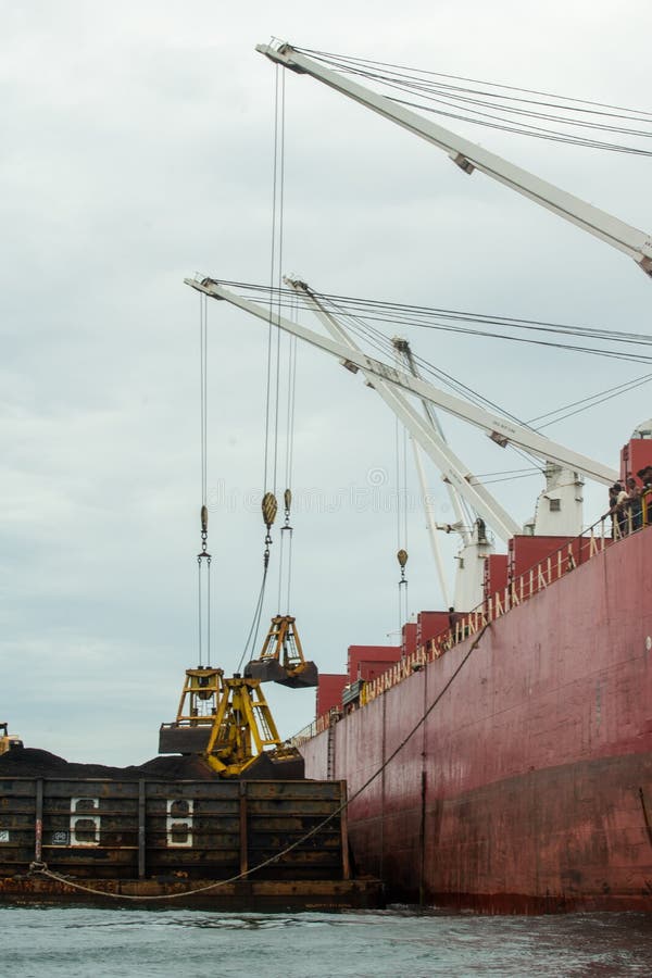 Loading Coal from Cargo Barges Onto a Bulk Vessel Using Ship Cranes ... Loading Coal from Cargo Barges Onto a Bulk Vessel Using Ship Cranes ...