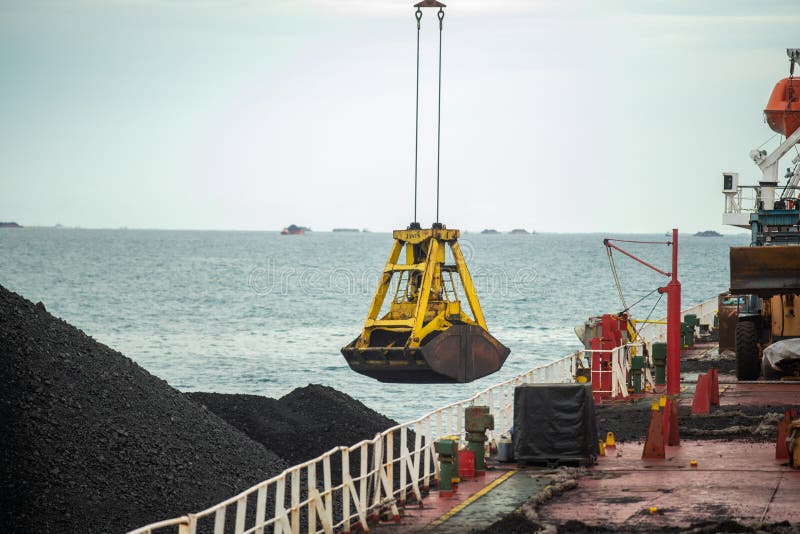 Loading Coal from Cargo Barges Onto a Bulk Vessel Using Ship Cranes in ...
