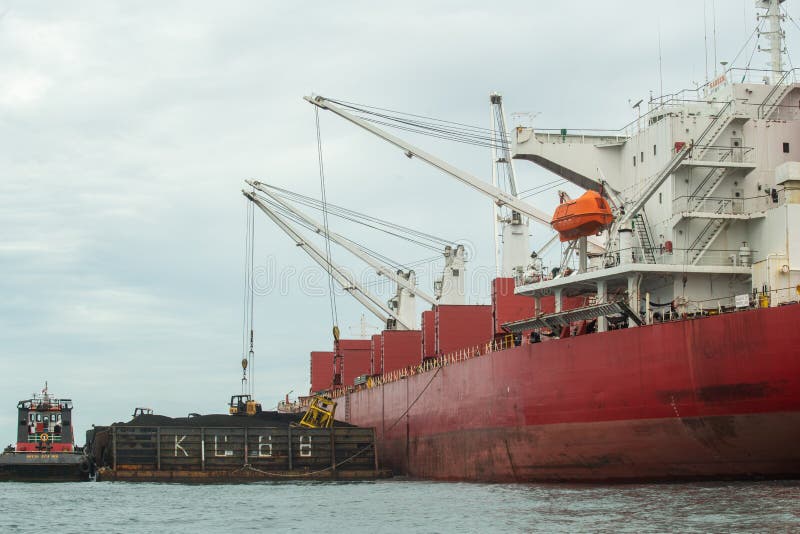 Loading Coal from Cargo Barges Onto a Bulk Vessel Using Ship Cranes ...