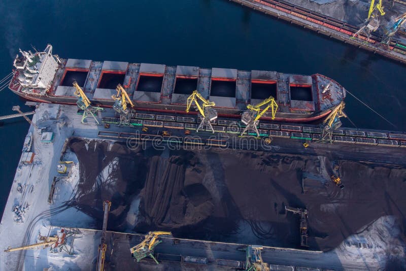 Loading Coal Mining in Port on Cargo Tanker Ship with Crane Bucket of ...