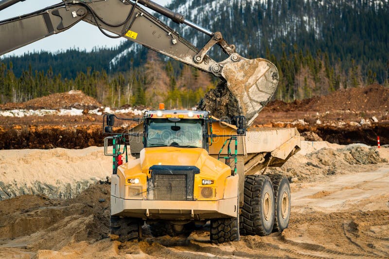 Loading Dirt into a Dumper Using an Excavator Stock Photo - Image of ...