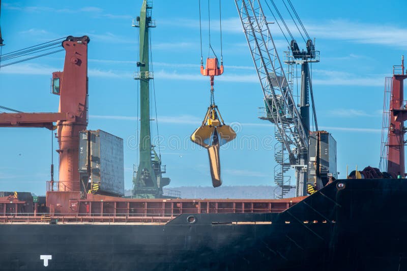 Loading Dry Cargo Ship of Wheat by Cranes in Port. Loading into Holds ...