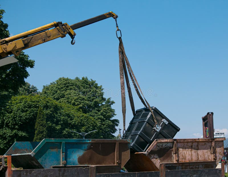 Loading Garbage Containers into a Truck Using a Crane. Slinger Works ...