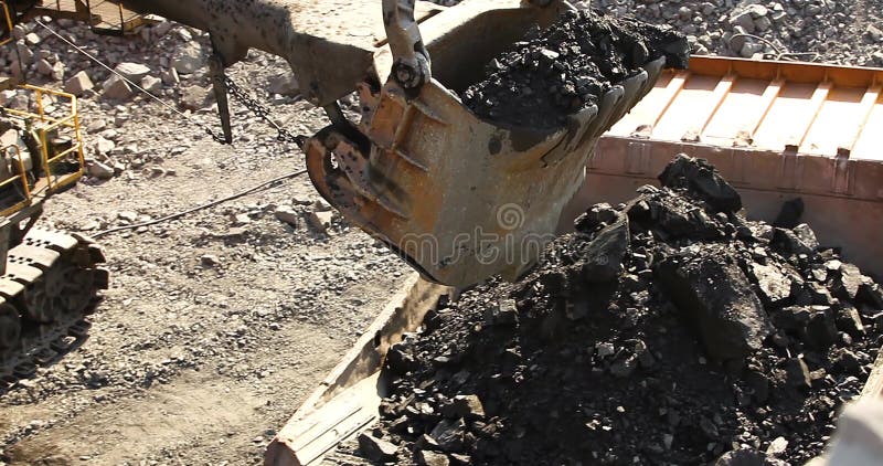 Loading Iron Ore into Mining Excavator. a Large Mining Excavator is ...