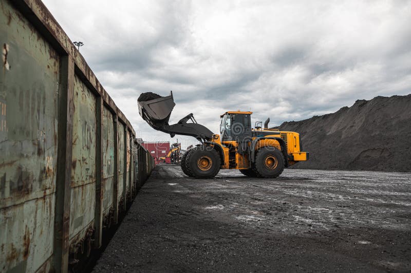 Loading of an Loader into Railway Wagons. Excavator Loading Coal into ...