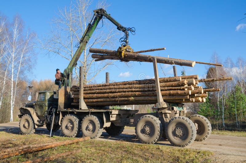 Loading logs onto a stack. editorial stock image. Image of machine ...
