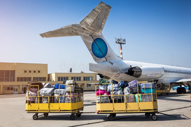 Loading Luggage on the Plane. Transportation of Baggage in Trailers To ...
