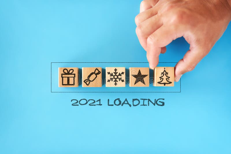 2021 Loading. Man Stack Wooden Cubes with Christmas Symbols - Tree ...