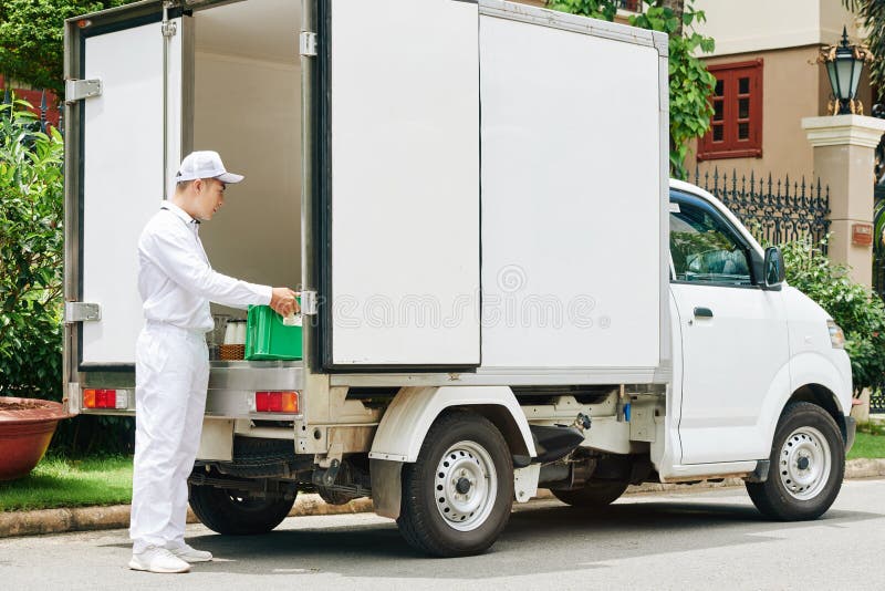 Loading milk float stock image. Image of occupation - 192399951