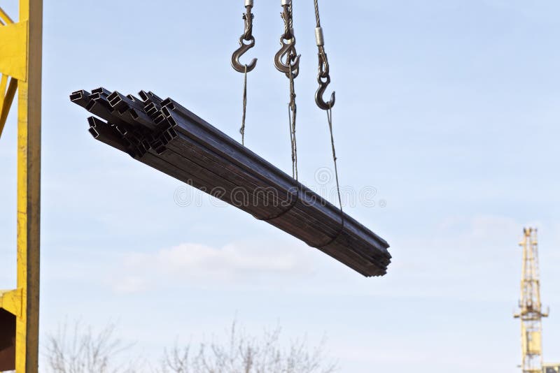Loading a Pack of a Rectangular Pipe in a Warehouse Stock Photo - Image ...