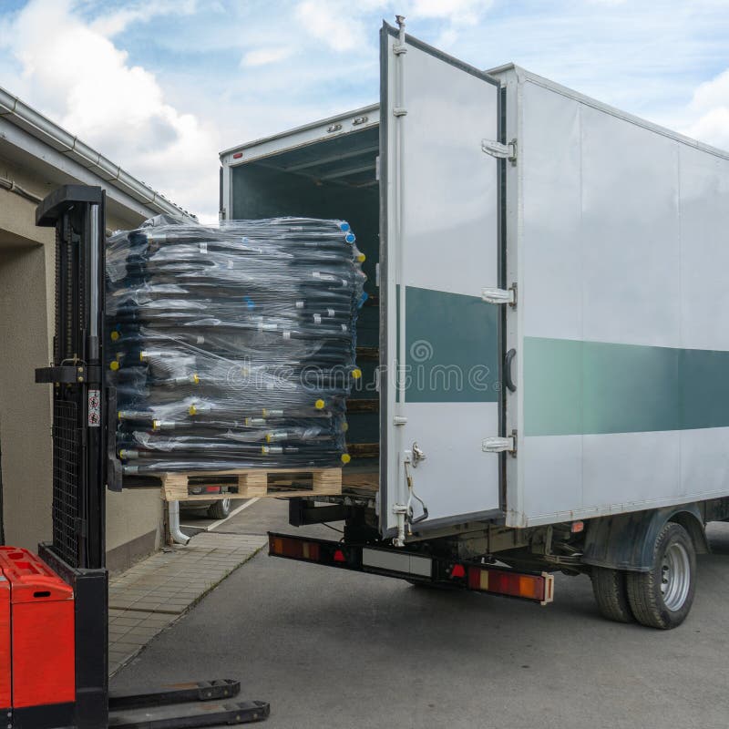 Loading the Product into a Truck Using a Forklift during the Day. Stock ...