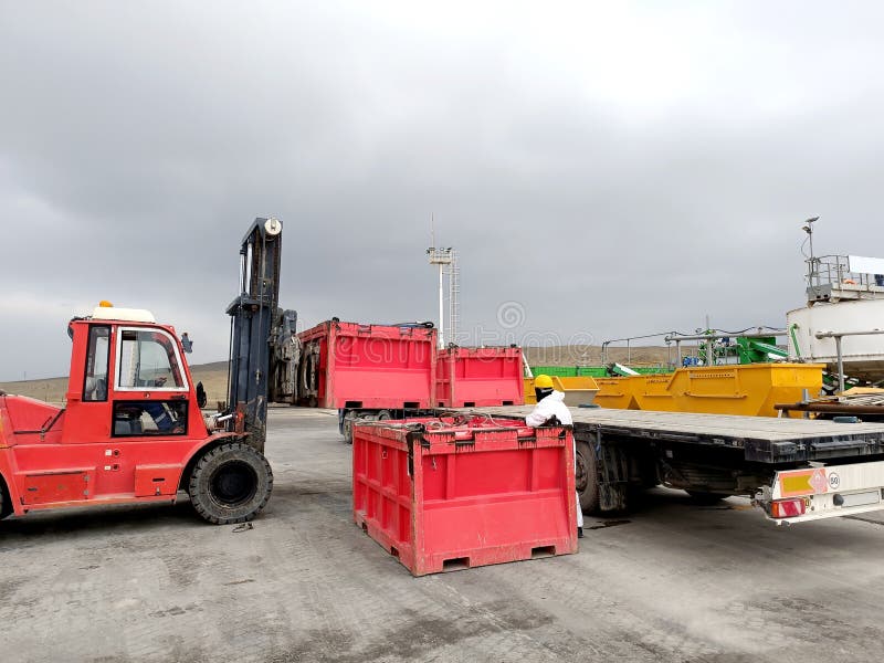 Loading Red Containers Full of Beft Waste Onto a Truck Using a Forklift ...
