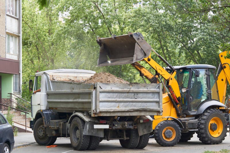 Loading Road Debris, Soil with an Excavator into a Dump Truck Stock ...