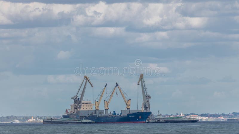 Loading and Unloading a Cargo Freight Ship with Industrial Cranes in ...