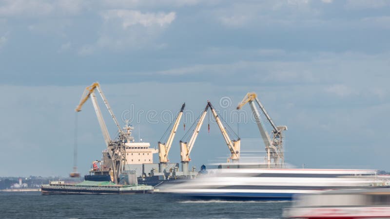 Loading and Unloading a Cargo Freight Ship with Industrial Cranes in ...