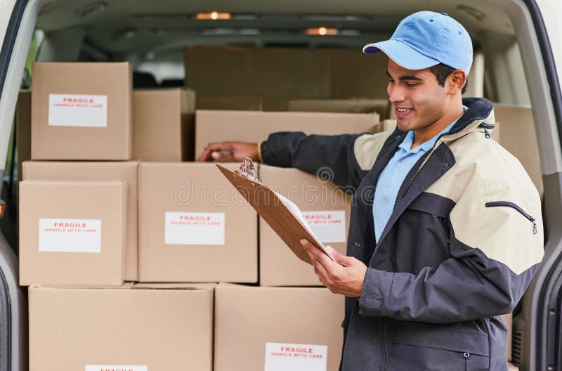 Loading the Van for His Day of Deliveries. a Delivery Man Standing Next ...