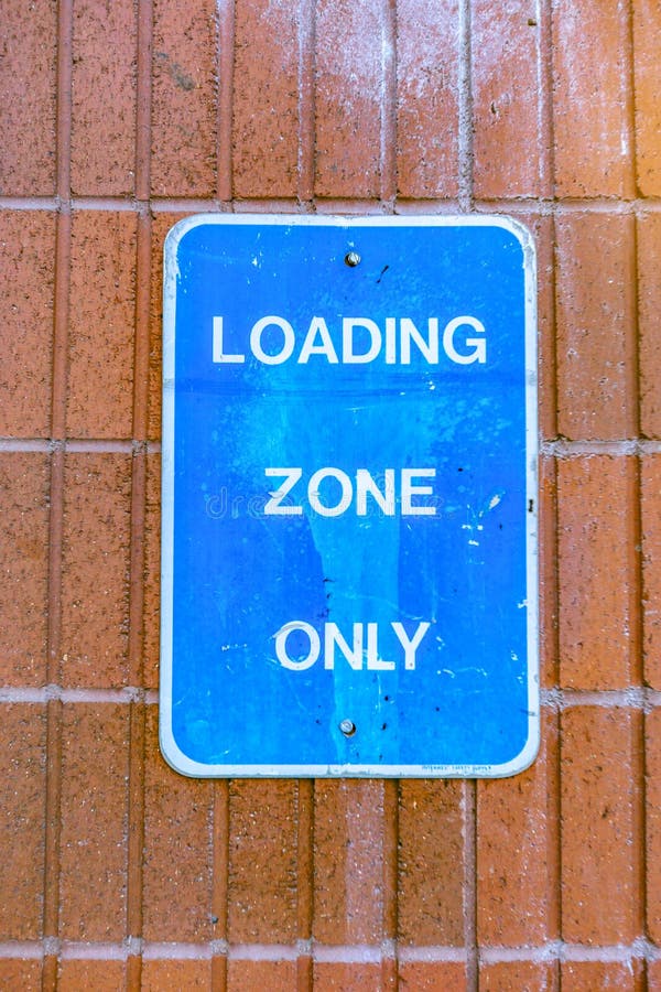 Loading Zone Sign on Brick Background Stock Image - Image of loading ...