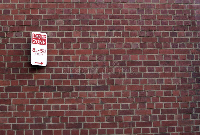 Loading Zone Sign on Brick Background Stock Image - Image of loading ...