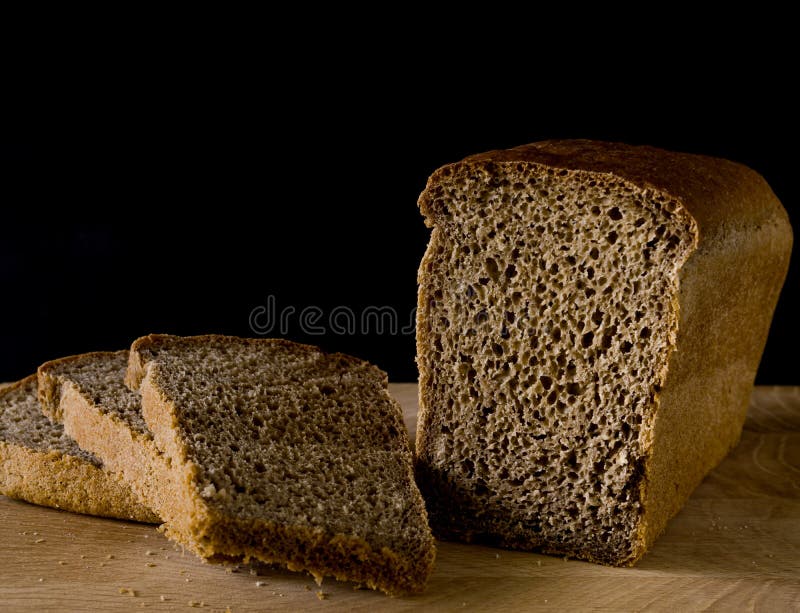 Loaf of Black Rye Bread, Cut into Pieces, in the Shape of a Brick on a ...