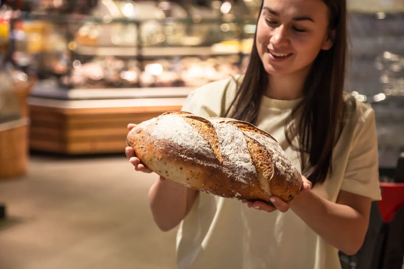 Loaf of Bread in Female Hands in a Supermarket. Stock Photo - Image of ...