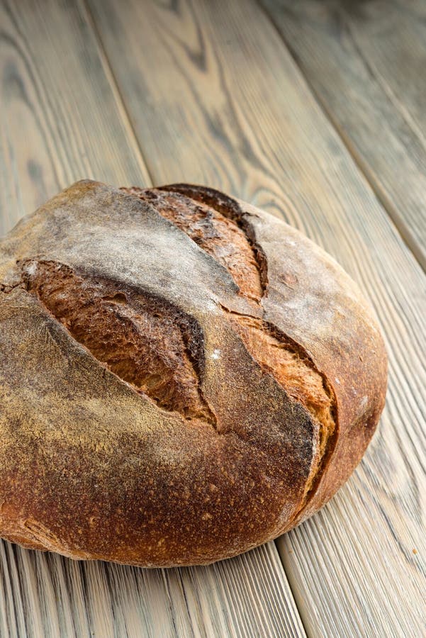 Loaf of Dark Bread Close-up on a Wooden Table.. Stock Image - Image of ...