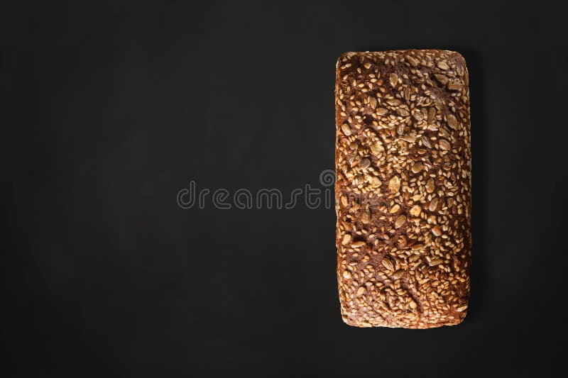 Loaf of Fresh Grain Bread on Black Background. Top View Stock Photo ...