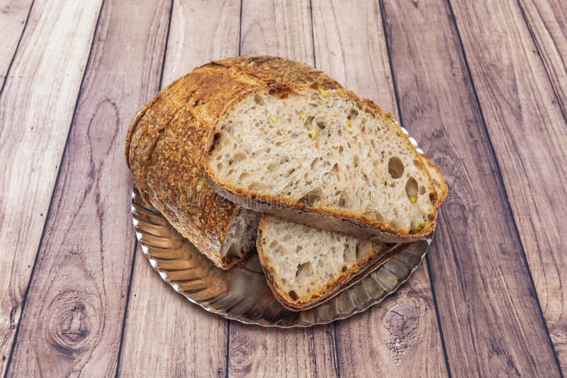 A Loaf of Village Bread with Some Cereals Inside, Cut into Slices Stock ...