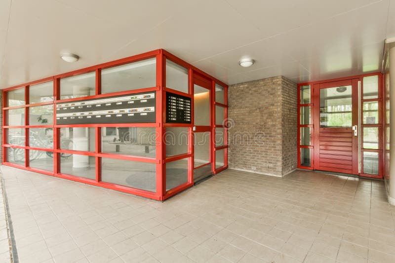The Lobby of a Building with Red Doors and Windows Editorial Stock ...