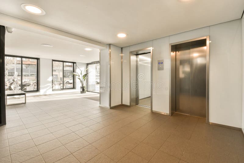 A Lobby with Elevators and Windows in a Building Stock Photo - Image of ...