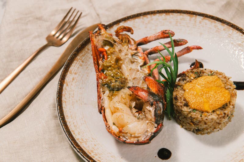 Lobster with Risotto on a White Plate with Fork and Knife. Stock Image ...