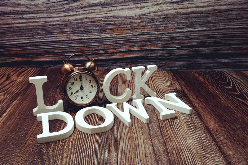 Lock Down Alphabet Letters with Alarm Clock on Wooden Background Stock ...