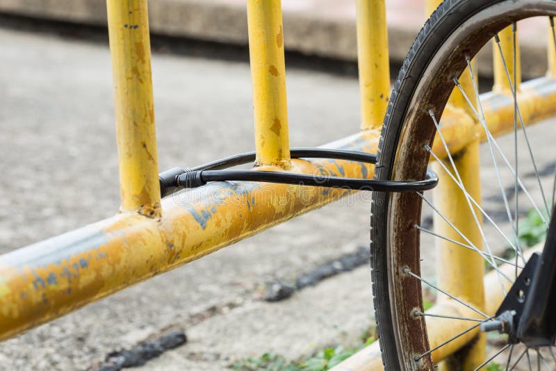 Lock the Front Wheels Bicycle on Yellow Steel Stock Image - Image of ...