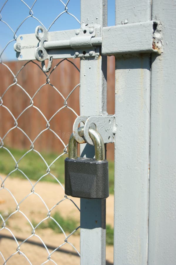 Lock Hangs on Fence Door Closeup Vertical View Stock Photo - Image of ...