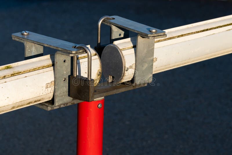 Lock Securing Rail on a Red Pole in a Bright Outdoor Setting Stock ...