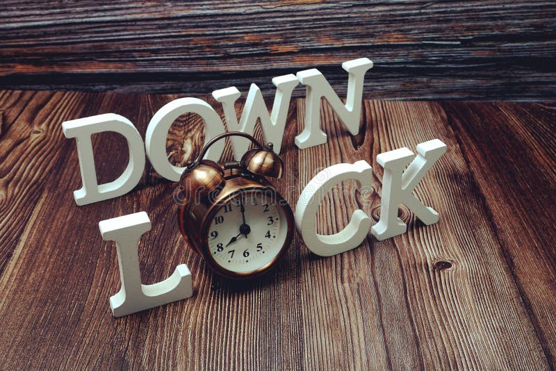 Lock Down Alphabet Letters with Alarm Clock on Wooden Background Stock ...