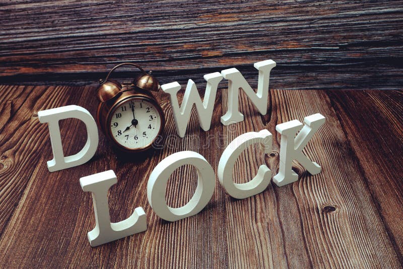 Lock Down Alphabet Letters with Alarm Clock on Wooden Background Stock ...