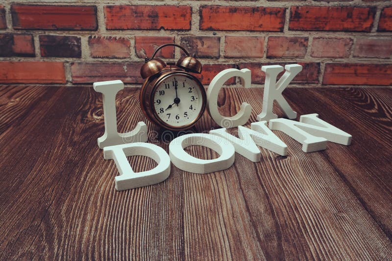 Lock Down Alphabet Letters with Alarm Clock on Wooden Background Stock ...