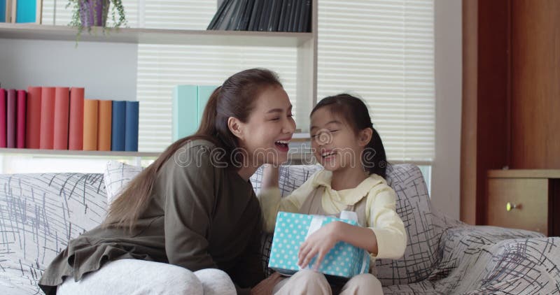 Lovely Daughter Surprise Mother With Large Present On Birthday Stock