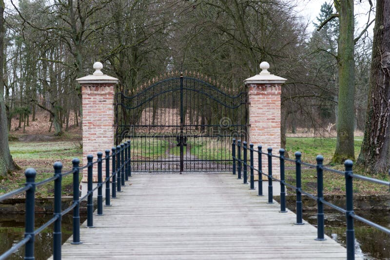 Locked Wrought Iron Gate with Two Stone Columns Stock Image - Image of ...