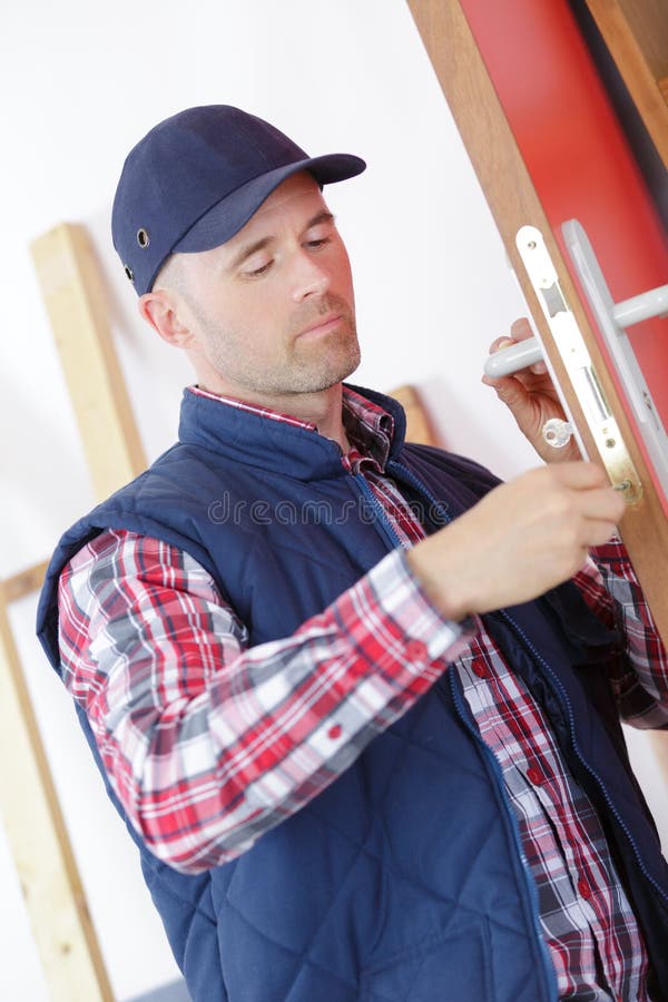 Lockpicker Fixing Door Handle at Home Stock Image - Image of holding ...