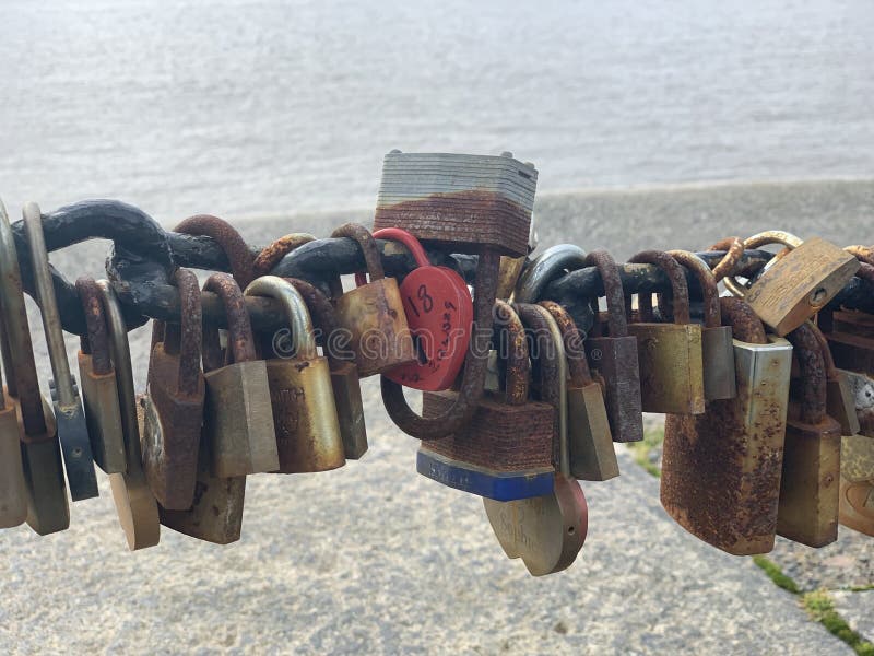 Locks of Many Colors and Shapes Next To Each Other Hanging from a Chain ...