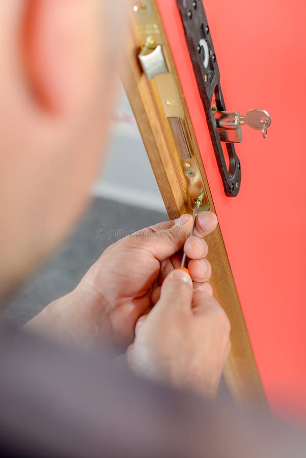 Locksmith Working with Door Lock Stock Photo - Image of screwing, locks ...