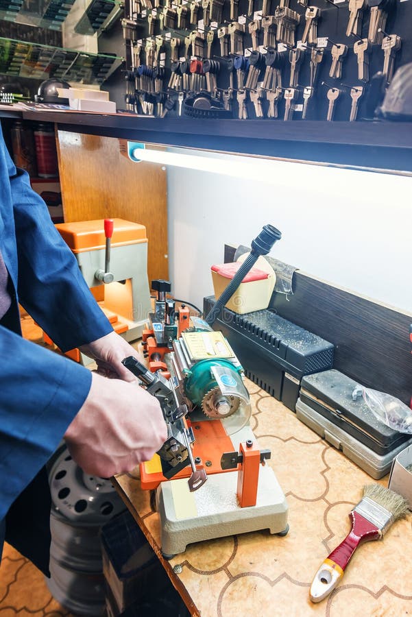 Locksmith makes new key stock image. Image of manufacturing - 108817913